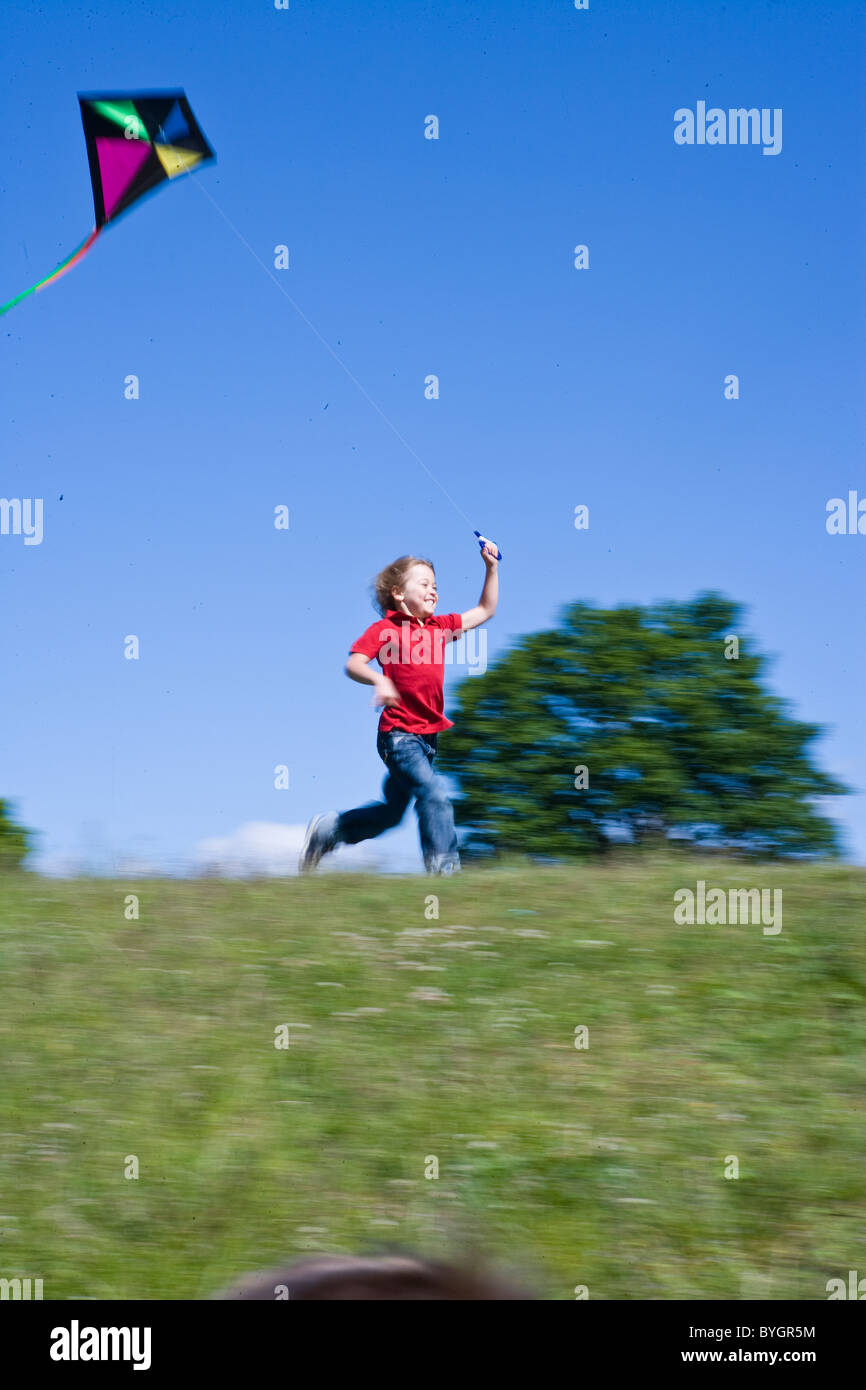 Boy running with kite Stock Photo - Alamy