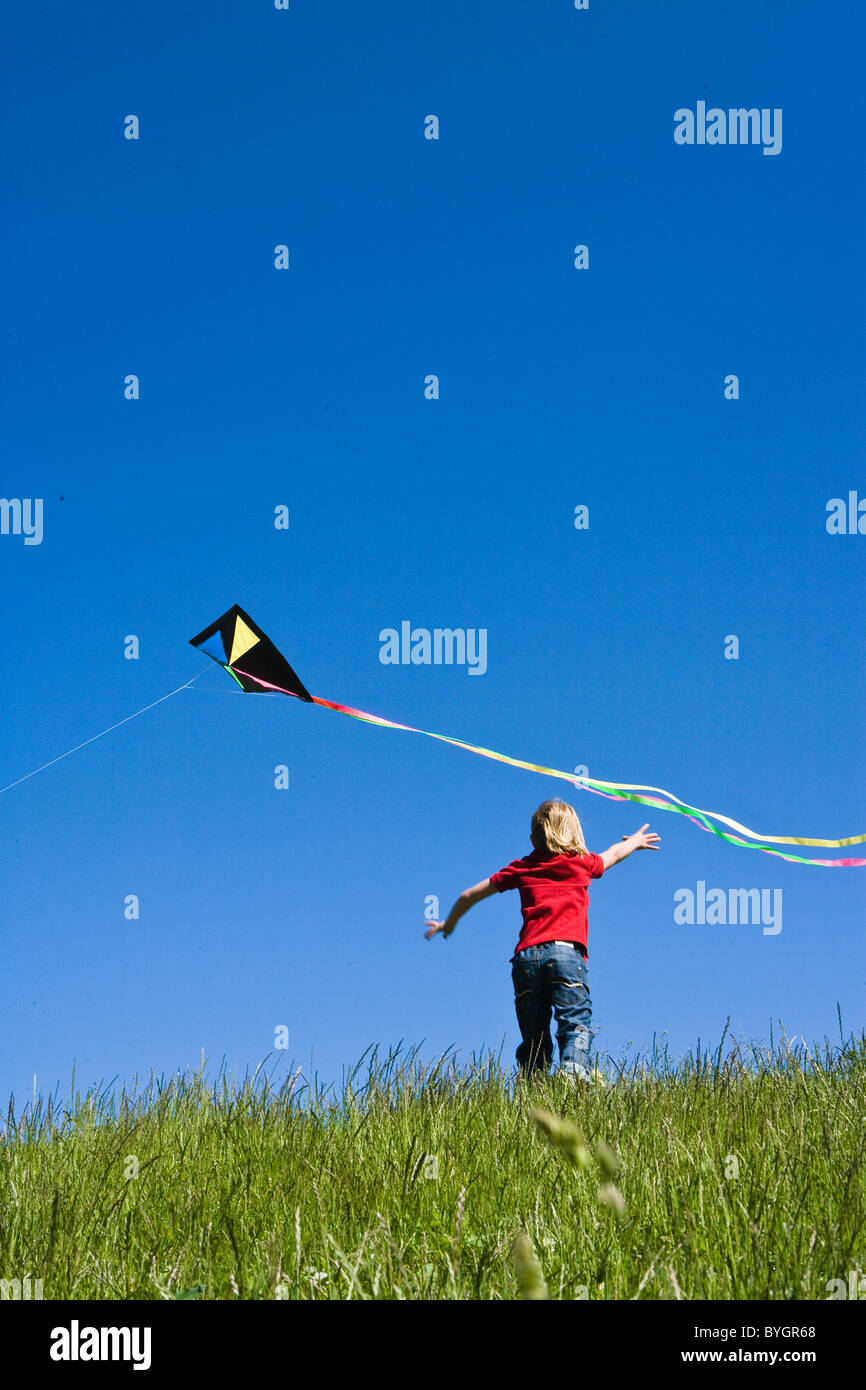 Boy running after kite Stock Photo - Alamy