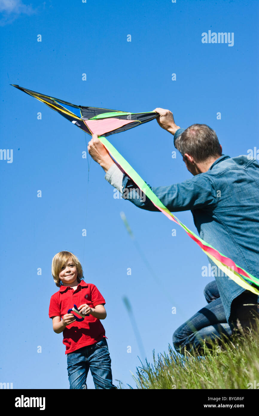 Father and son flying kite Stock Photo - Alamy