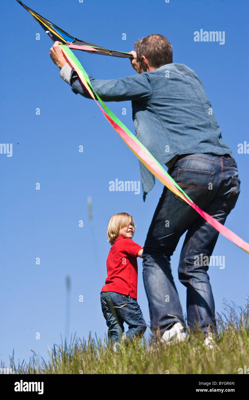 Father and son flying kite Stock Photo - Alamy
