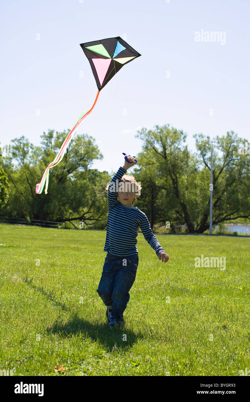 Boy flying kite in bright sunlight Stock Photo - Alamy