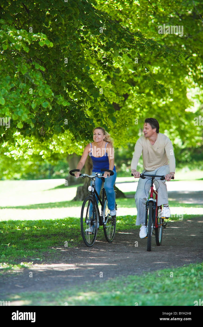 Couples biking park fun hi-res stock photography and images - Alamy
