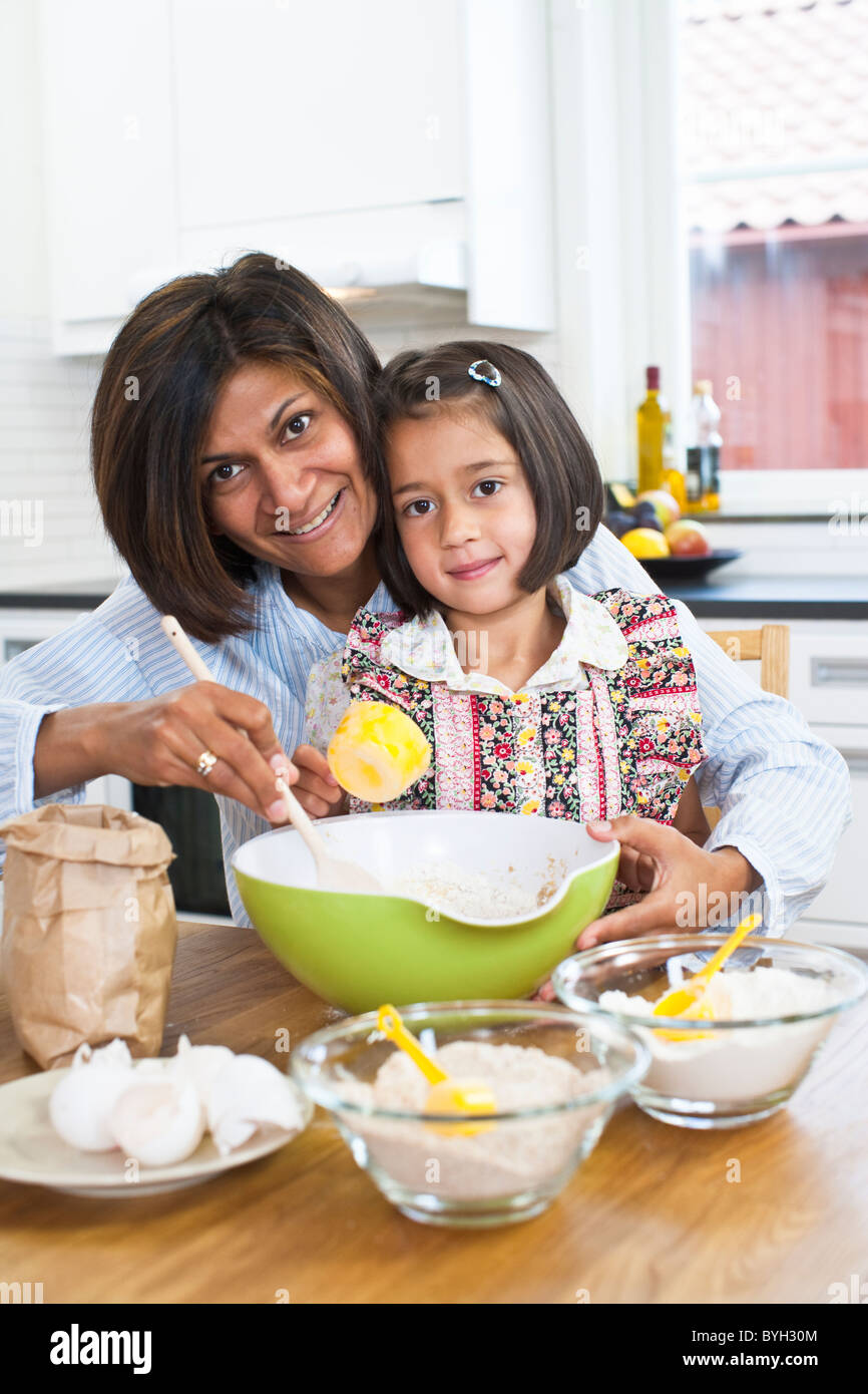 Portrait of mother baking with daughter in kitchen Stock Photo - Alamy
