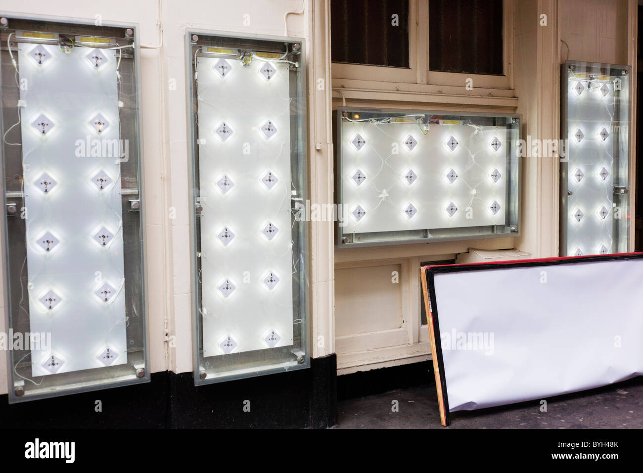 Changeable theatre production lightboxes, awaiting new posters outside ...