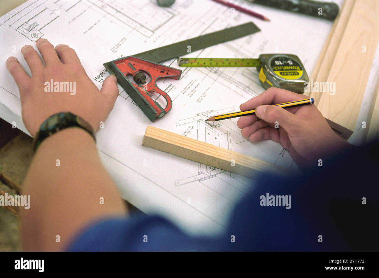 Woodworker making notes on plans Stock Photo - Alamy