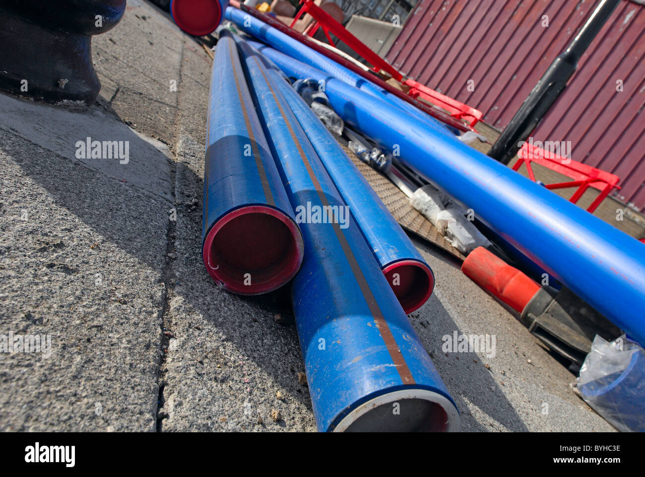 Utility pipes laying on the pavement Stock Photo - Alamy