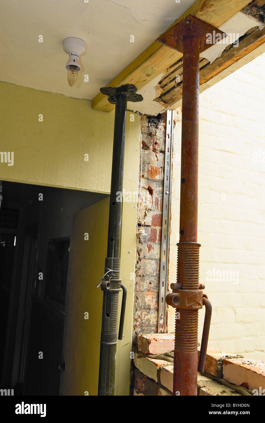 Acrow props supporting building during works Stock Photo - Alamy