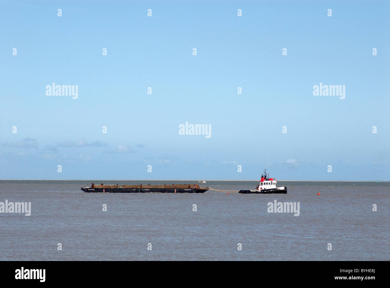 Tug boat pulling a barge of heavy duty material Great Yarmouth United ...