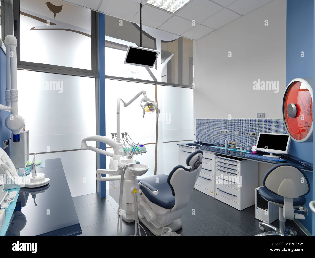 interior of dental surgery with dental chair with large glass window ...