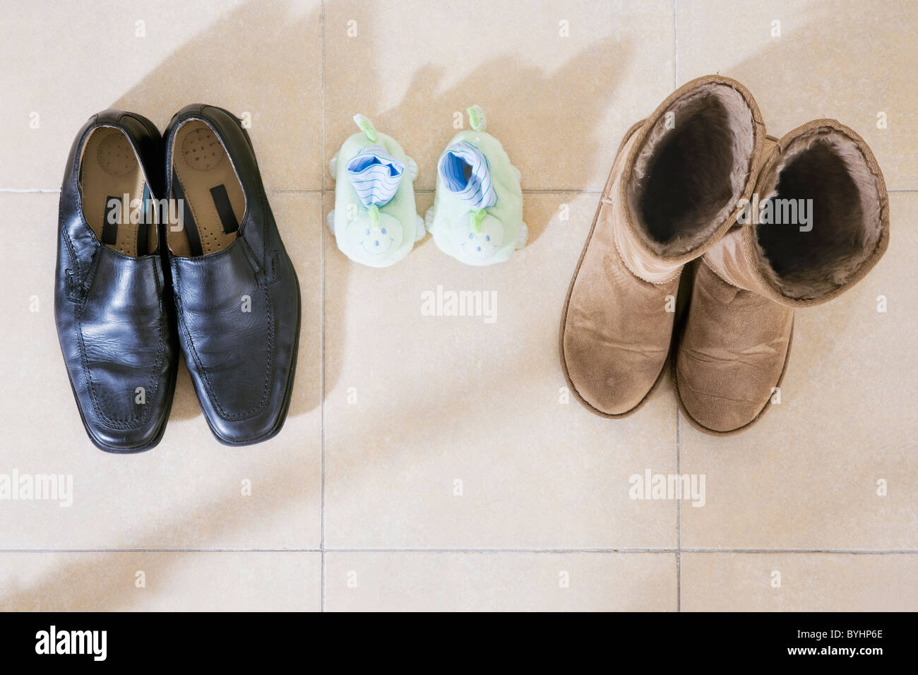 Three pairs of shoes by the front door of a home Stock Photo - Alamy