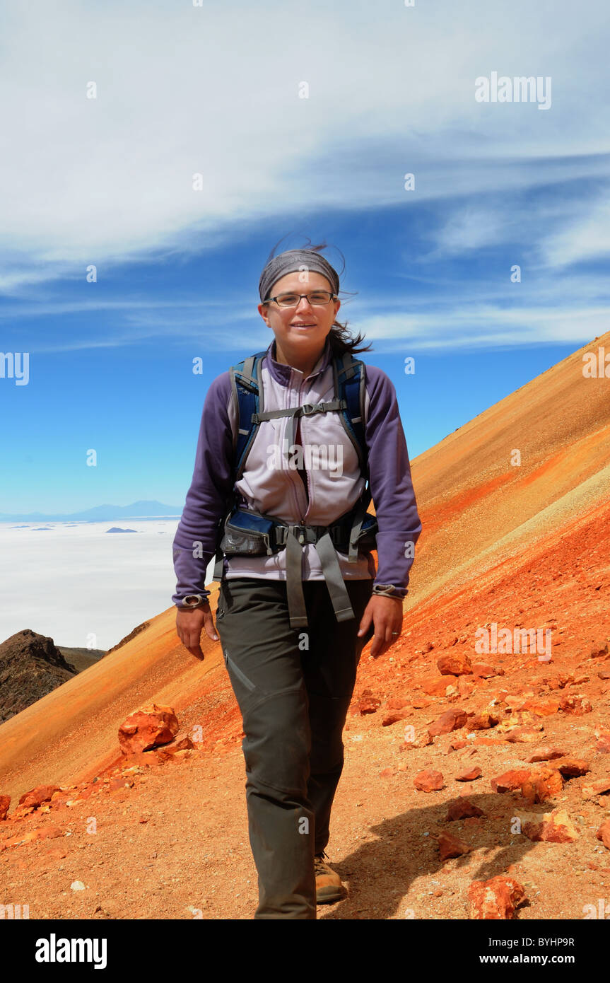 A lady walker nearing the summit of Tunupa volcano in the Salar de ...