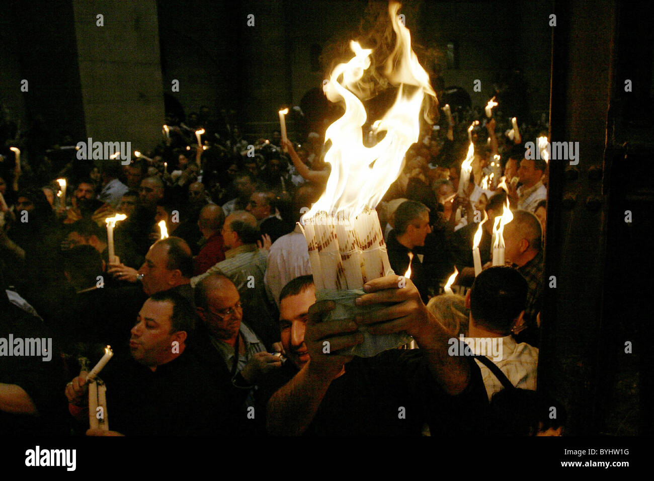Christian Orthodox worshippers hold up candles lit from the 'Holy Fire ...