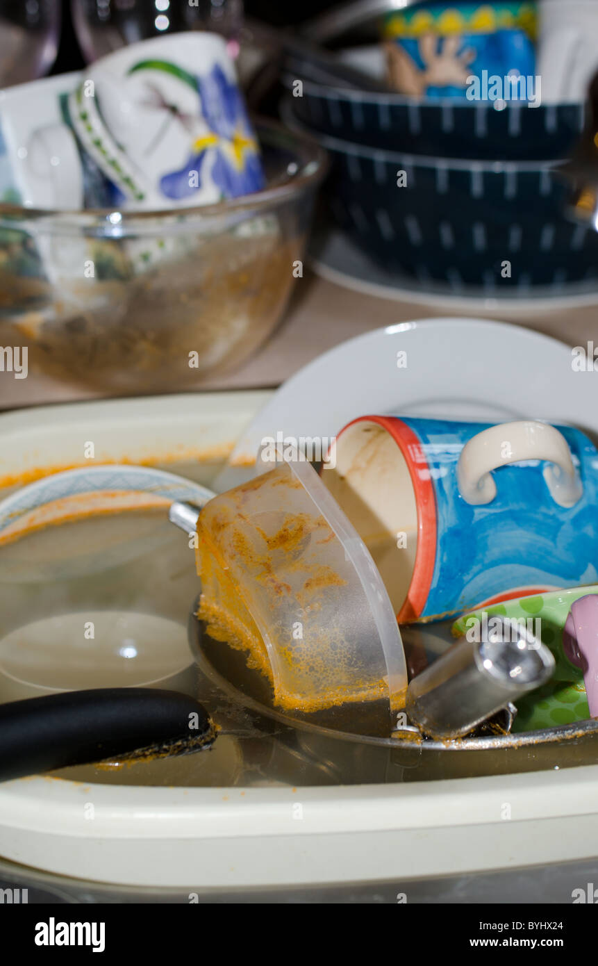 Kitchen sink full of dirty dishes Stock Photo - Alamy