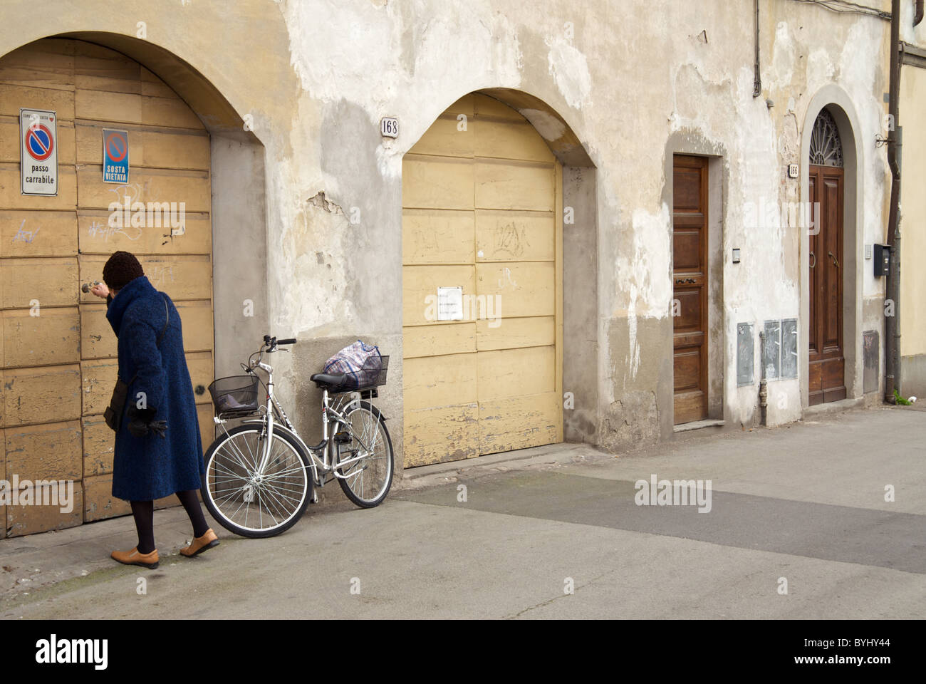 An elderly lady entering her home, Tuscany, Italy Stock Photo - Alamy