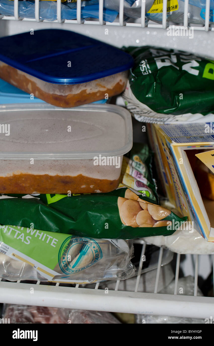 Household freezer with containers of home made meals and supermarket ...