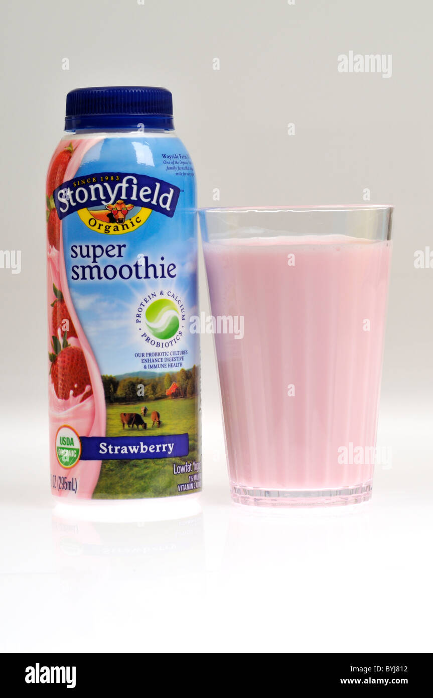 Glass of Stonyfield super smoothie with jug on white background, cutout ...