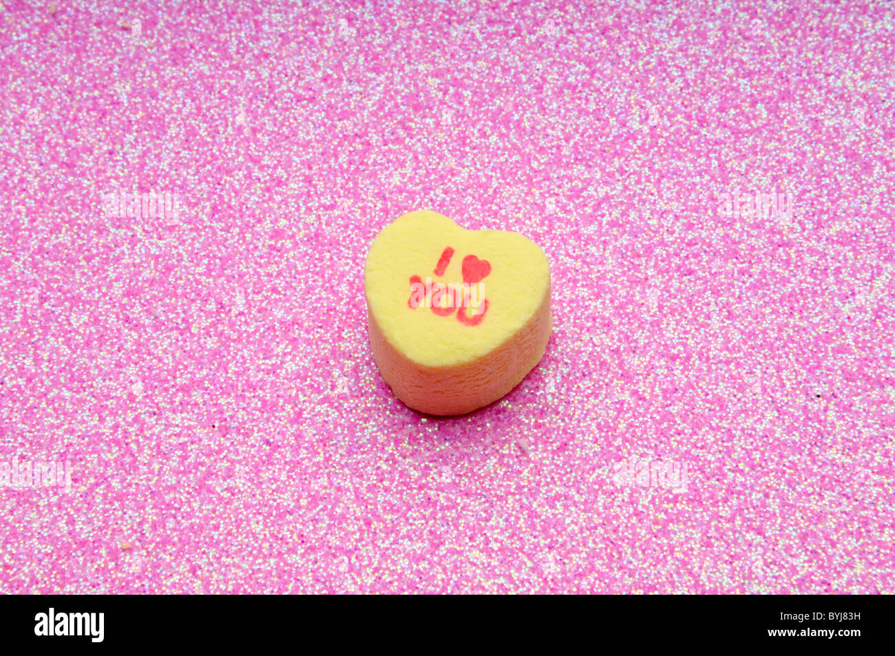 Valentines day candy on pink sparke surface Stock Photo - Alamy