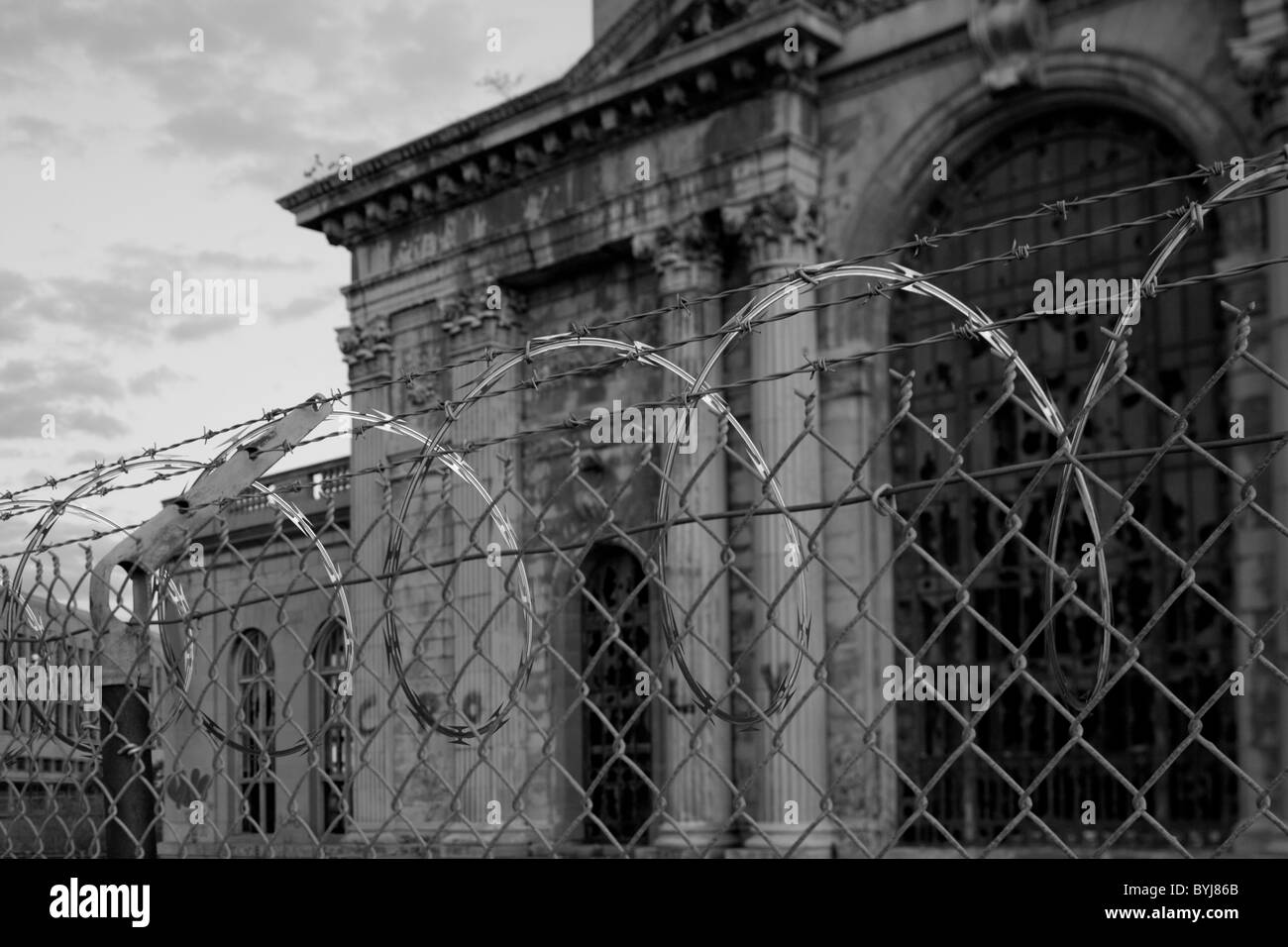 USA, Michigan, Detroit, Barbed wire surrounds abandoned Michigan ...