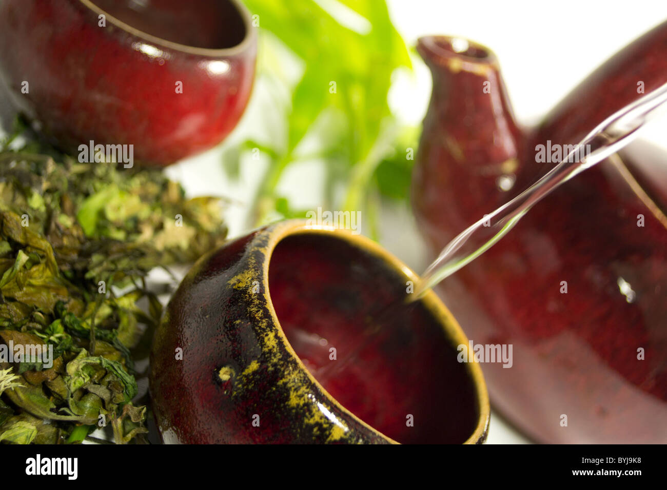 Pouring Tea into Cup Stock Photo - Alamy