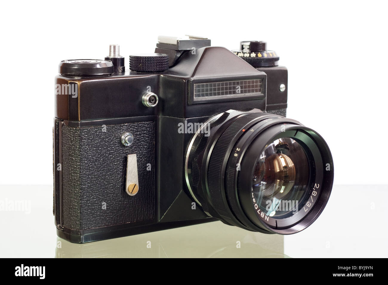 Old,dusty photo camera on glass table.White background Stock Photo - Alamy