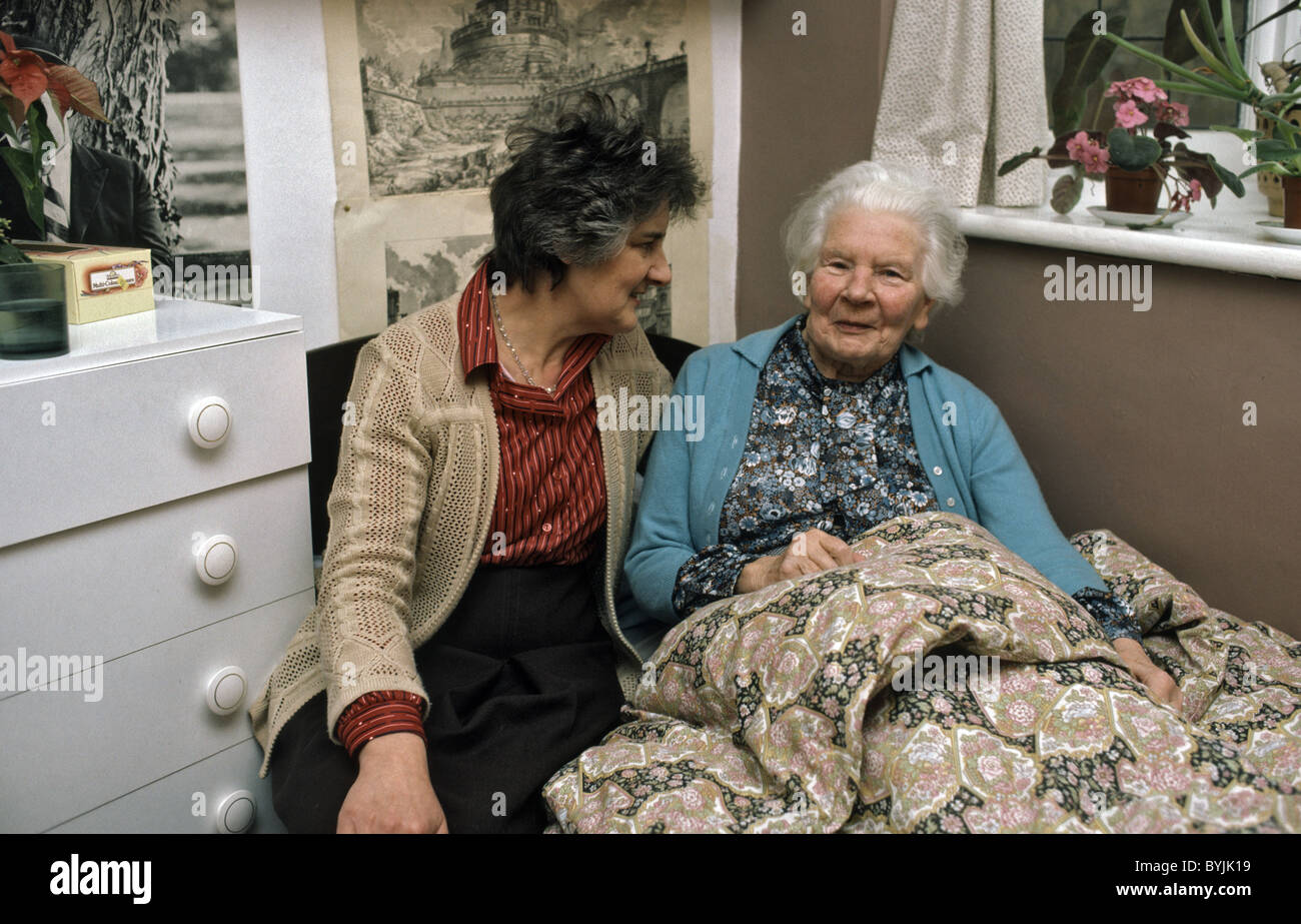 Helping carer helping frail old lady with dementia Stock Photo - Alamy
