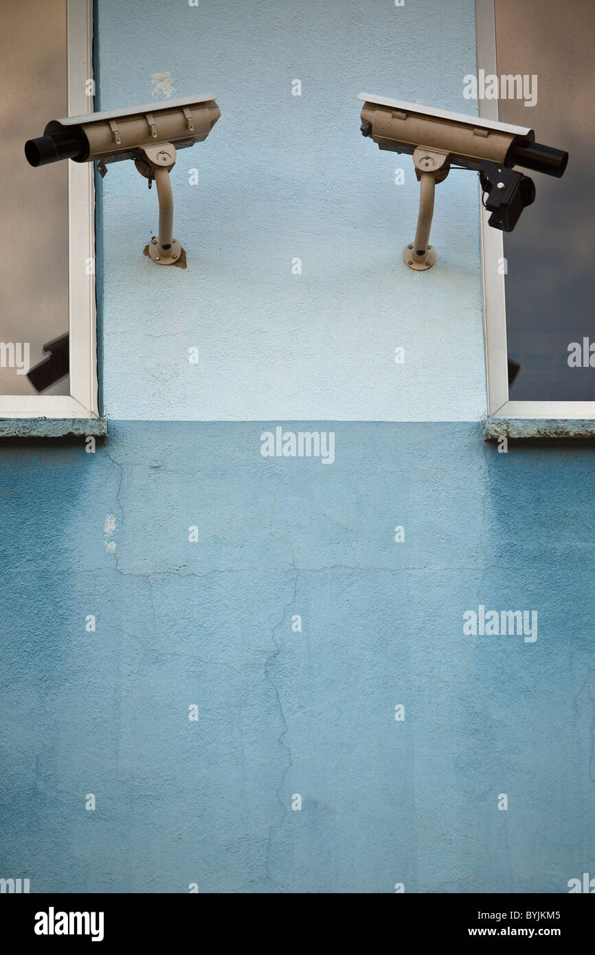 Two security cameras attached on old building Stock Photo - Alamy