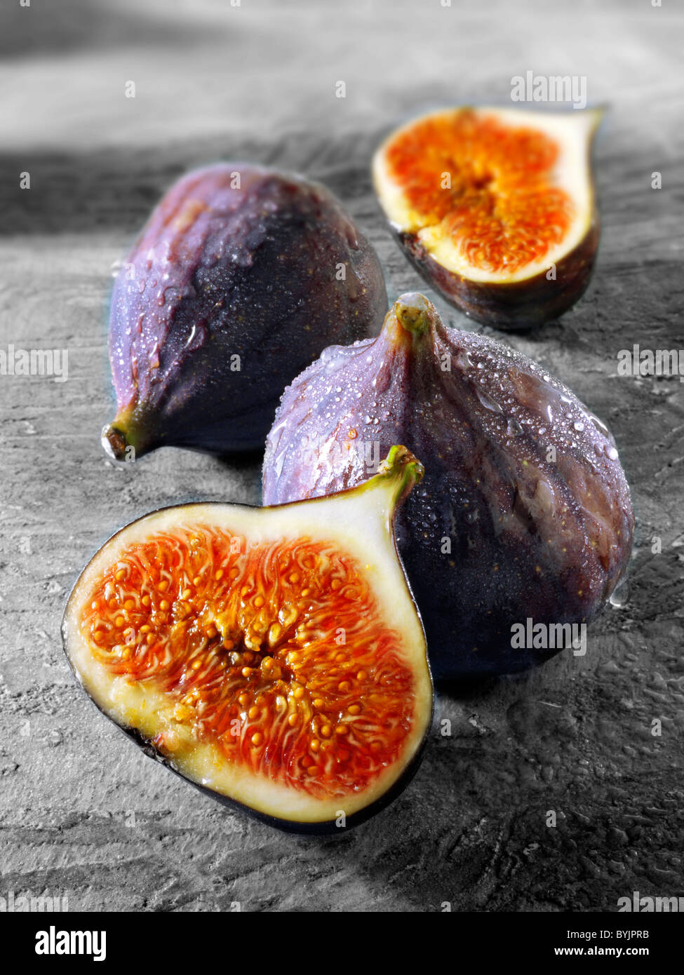 Close up of fresh whole & cut figs on a table setting Stock Photo - Alamy