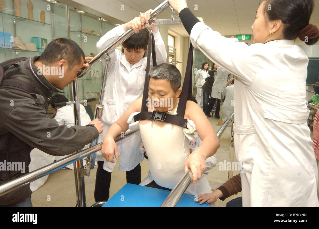 HALF MAN GETS INTO SHAPE FOR ARTIFICIAL LIMBS Medical staff, at the ...