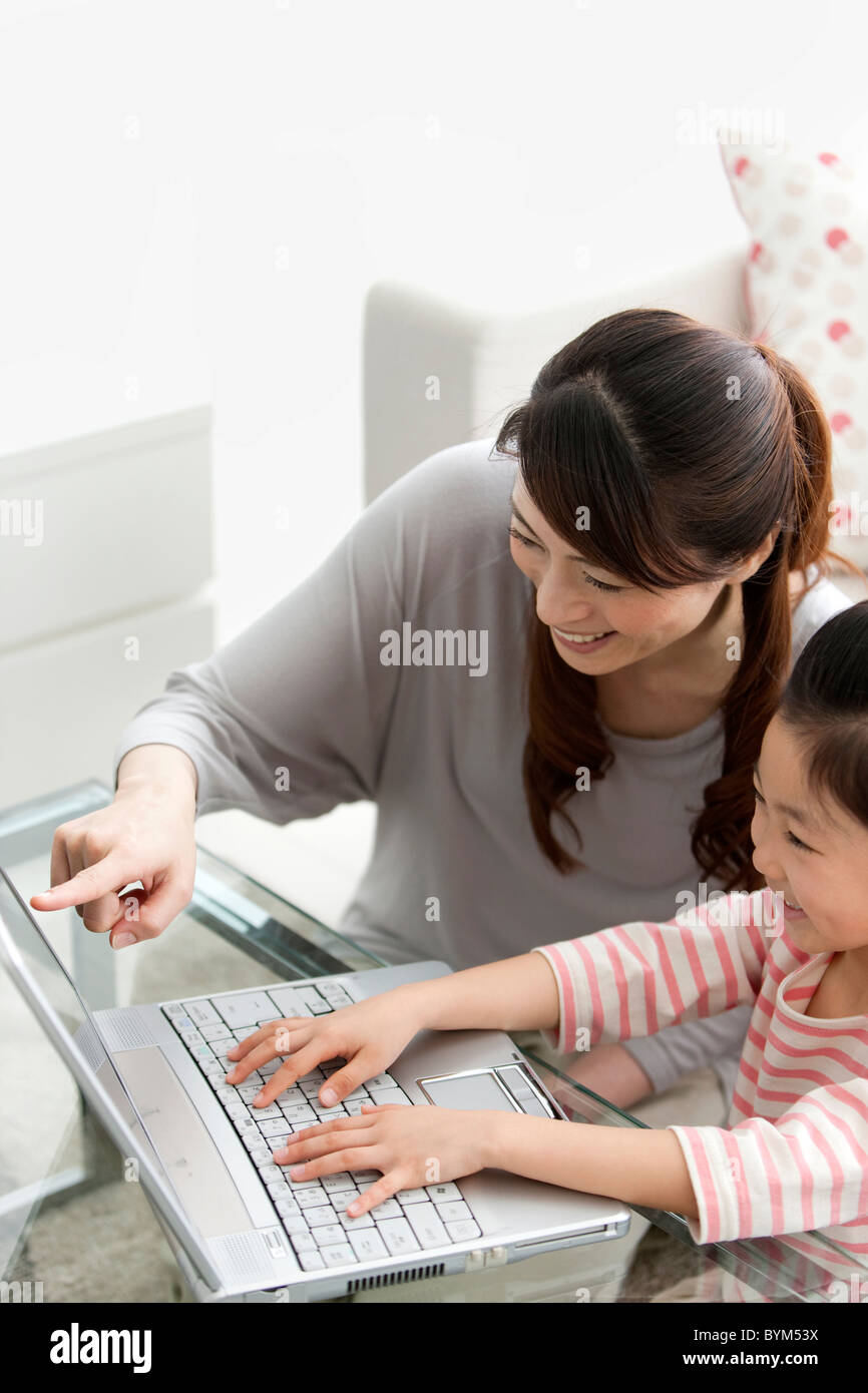 Mother and daughter using laptop Stock Photo - Alamy