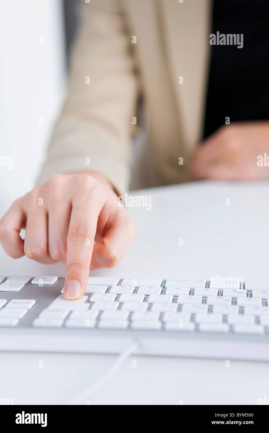Hand of woman pressing enter key Stock Photo - Alamy