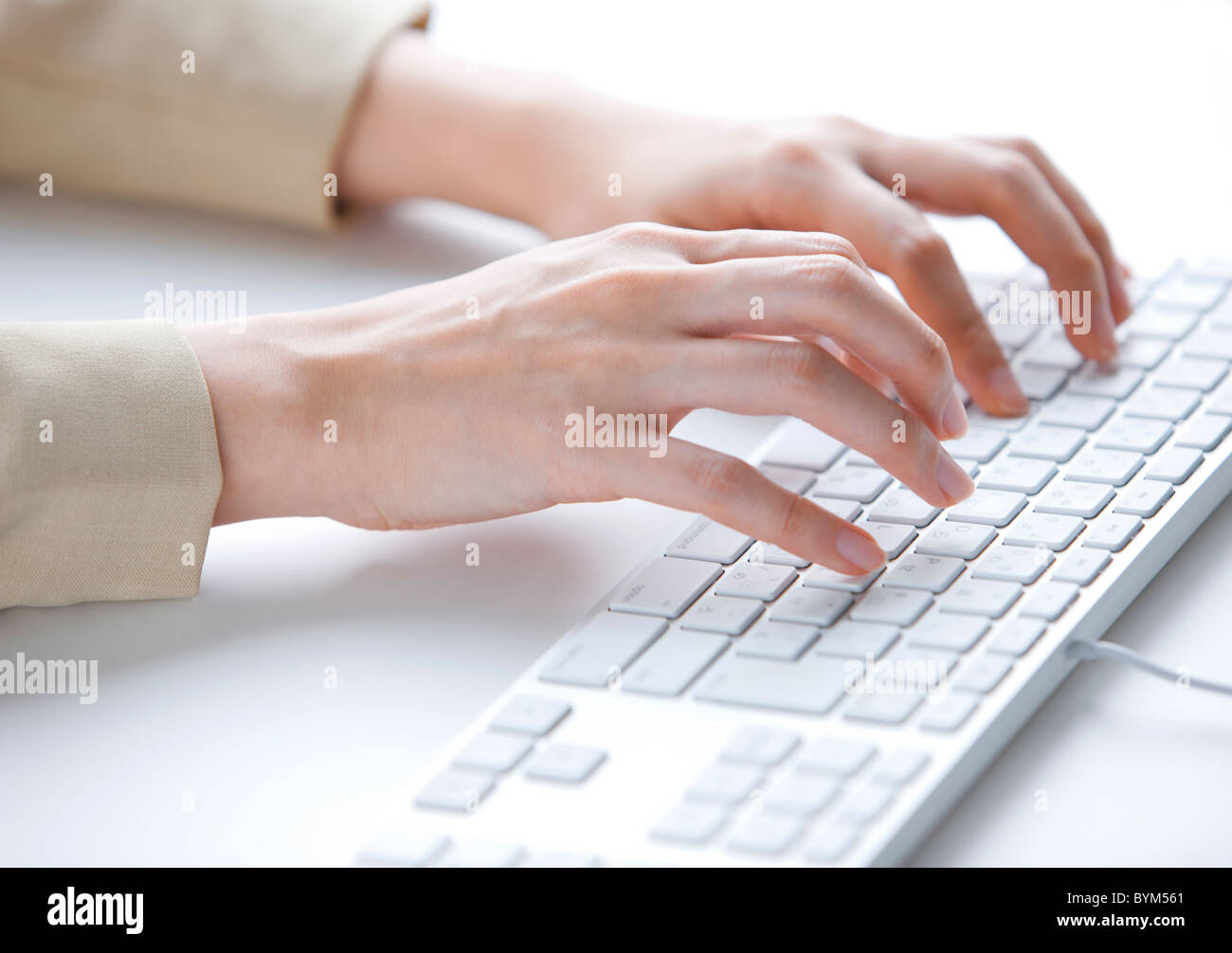 Hands of woman using computer keyboard Stock Photo - Alamy