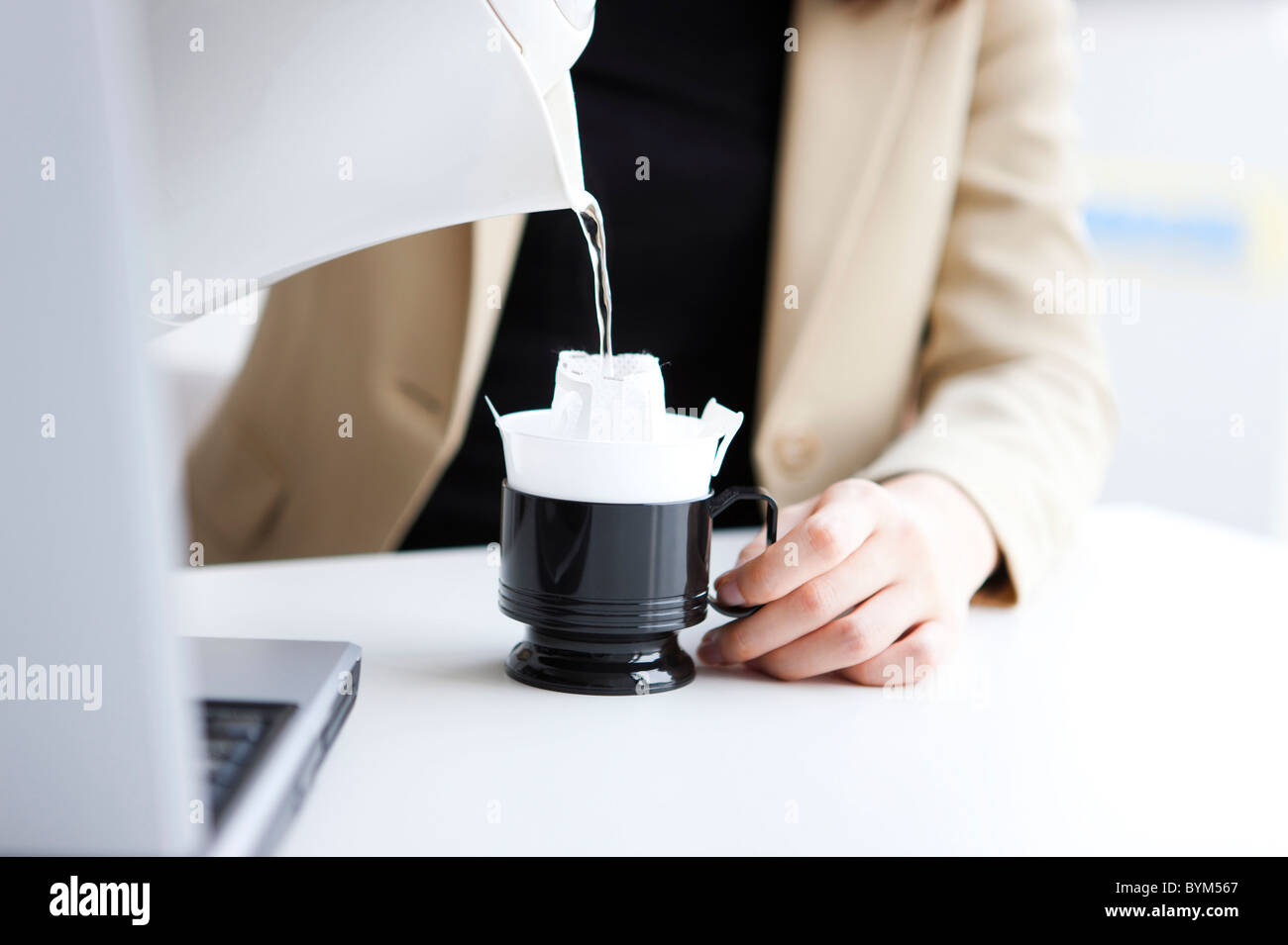 Woman making coffee Stock Photo - Alamy
