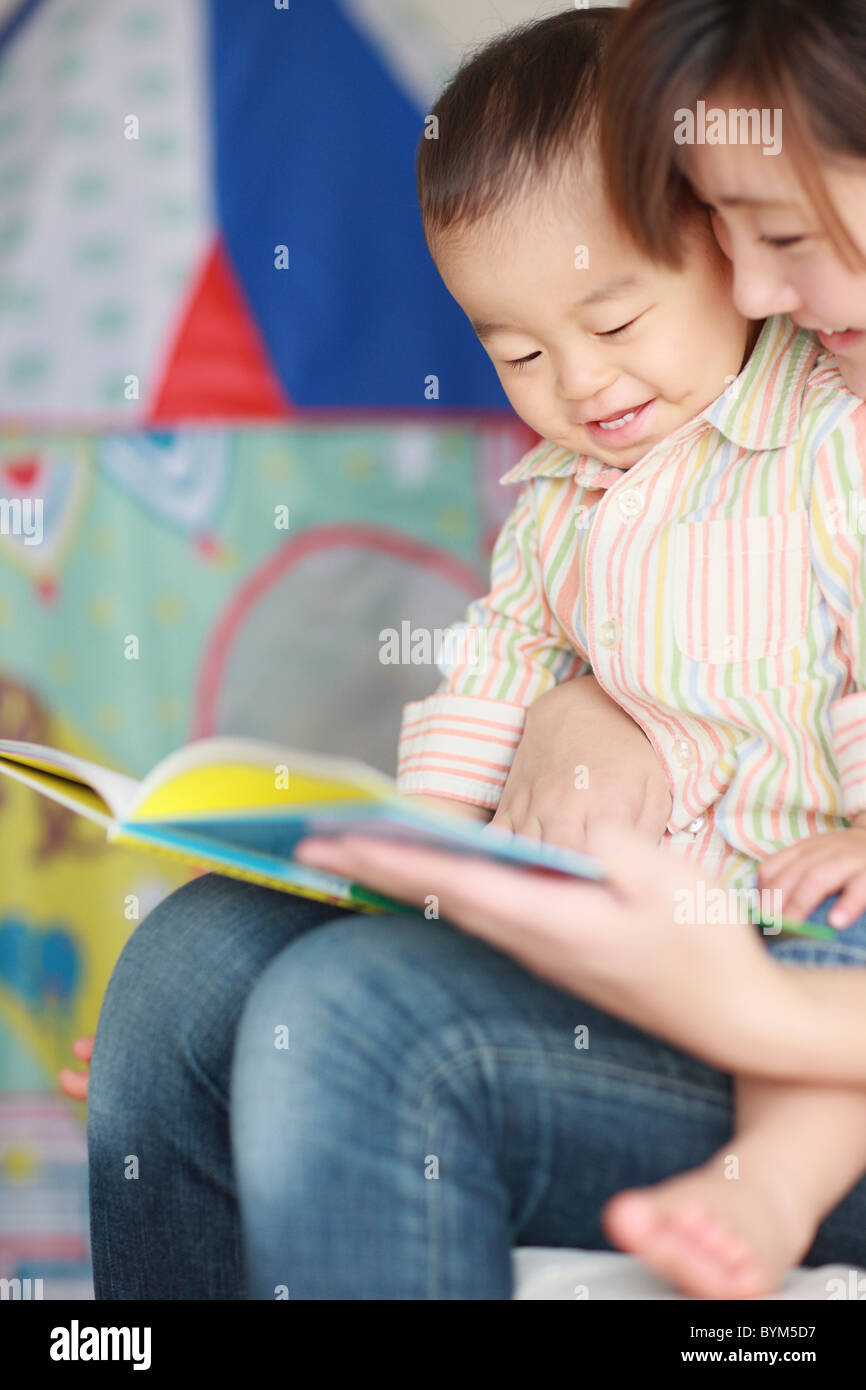 Mother Son Sitting Reading Book Lap Smiling Stock Photo - Alamy