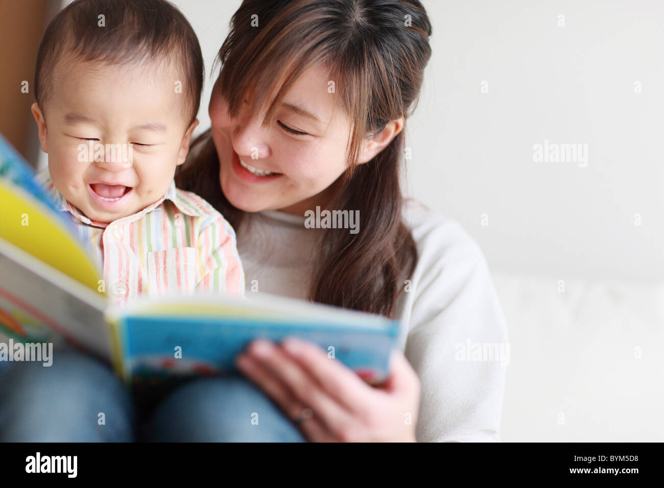 Mother Son Sitting Reading Book Lap Smiling Stock Photo - Alamy
