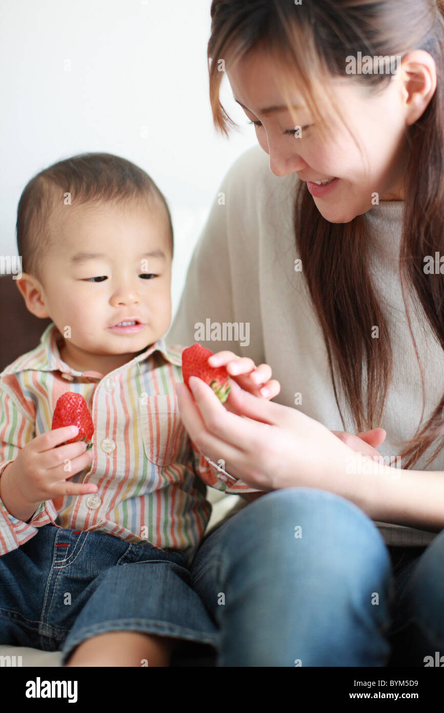 Mother Son Sitting Giving Strawberry Smiling Stock Photo - Alamy
