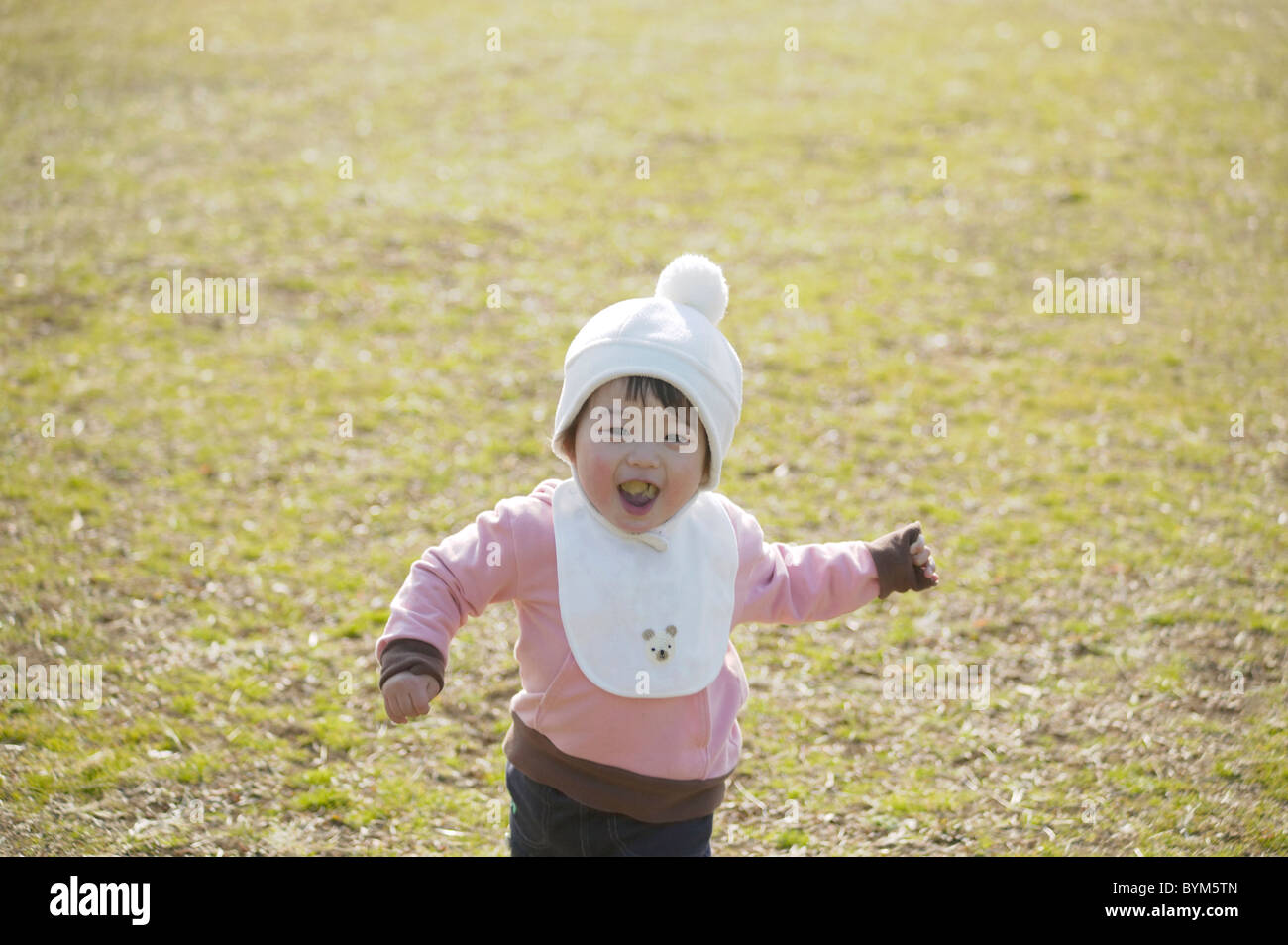 Baby Girl Running in Park Stock Photo - Alamy