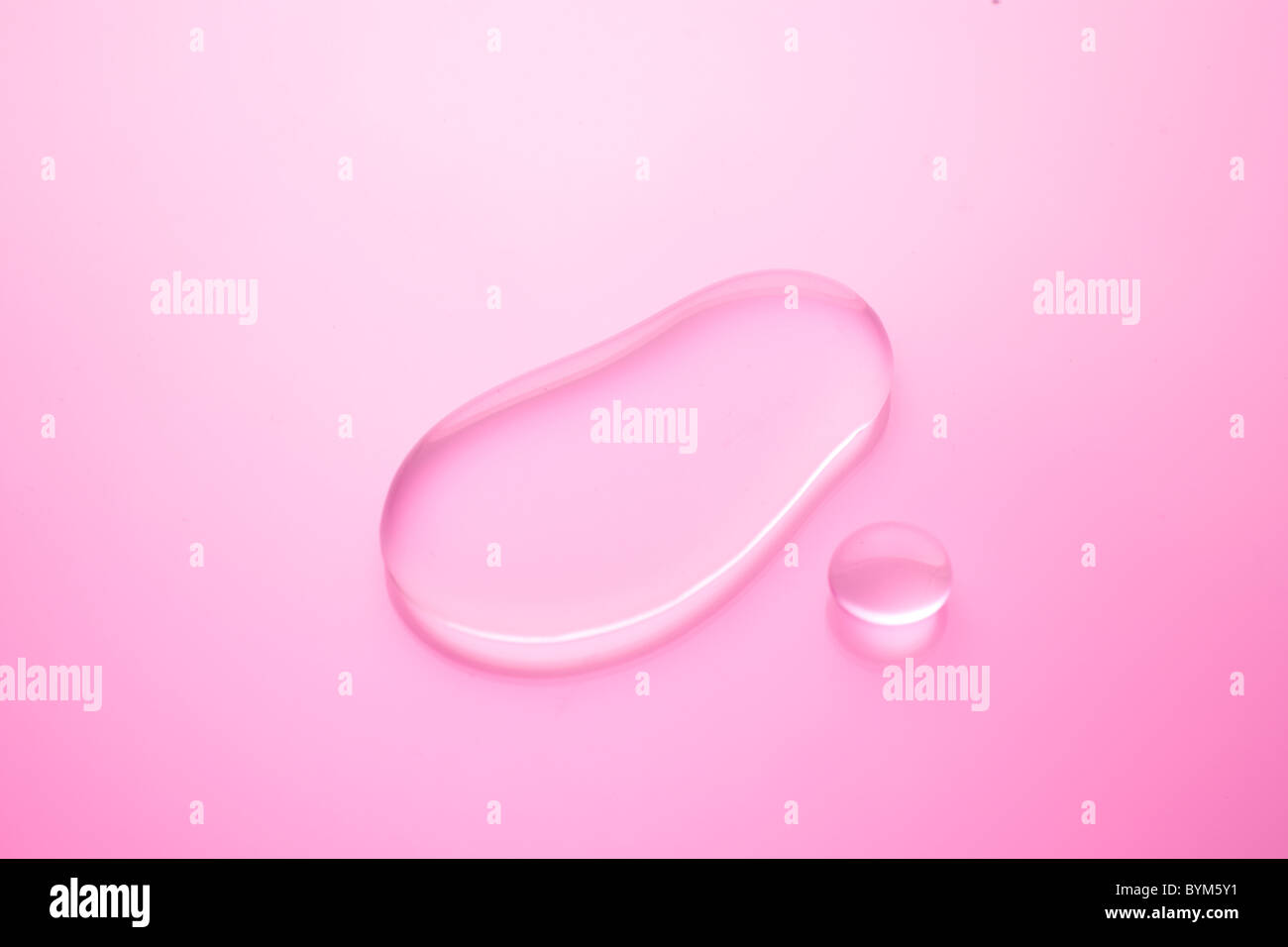 Water Drop on Pink Background Stock Photo - Alamy