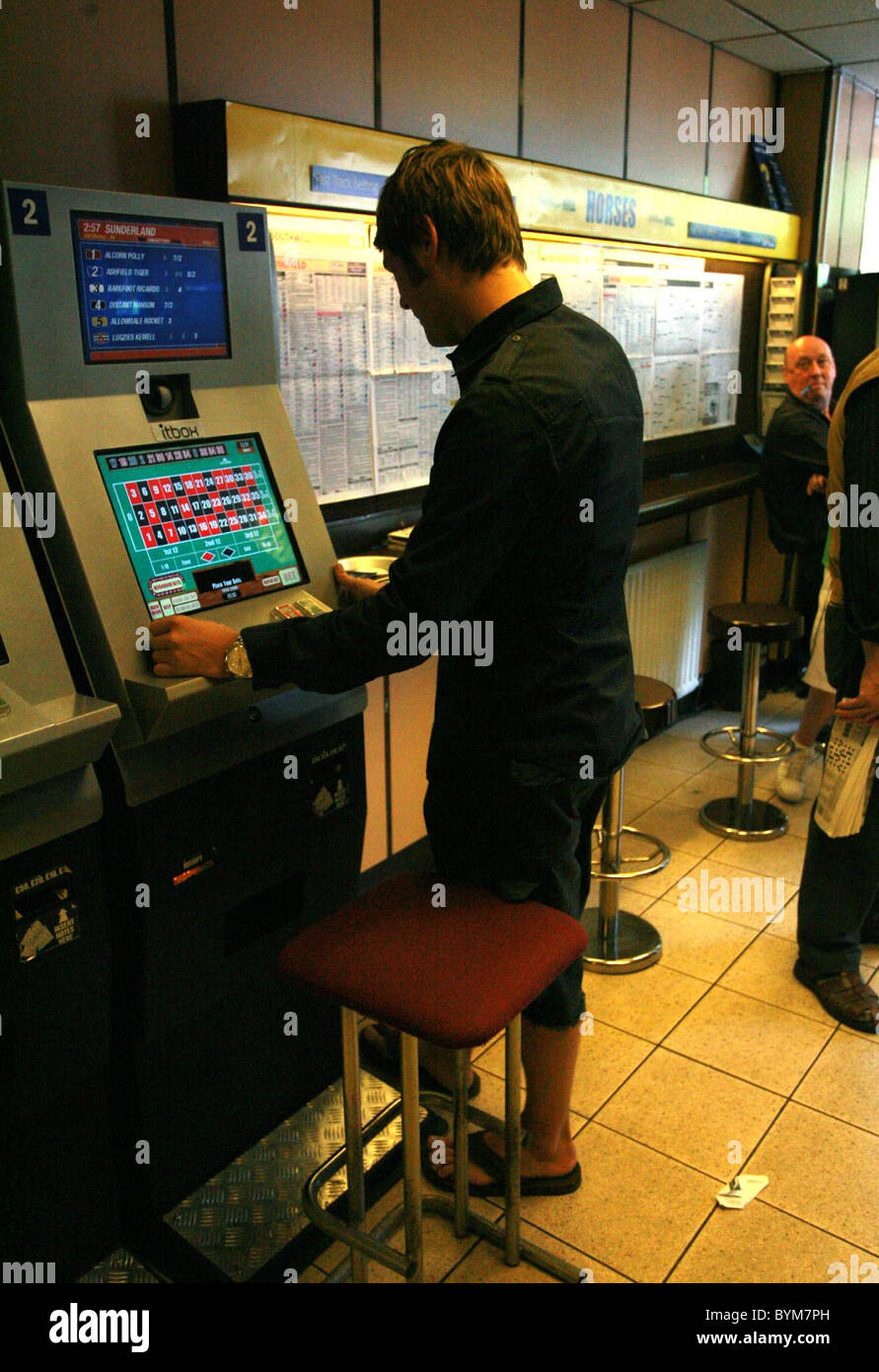 Brian McFadden placing a bet in a bookmakers in Primrose Hill London ...