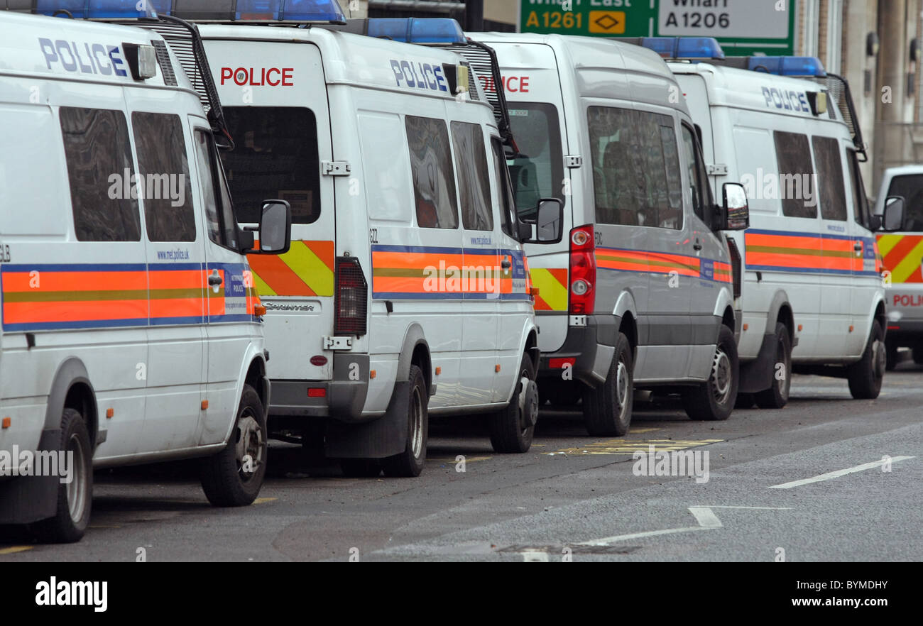 Police vans parked in a row by the side of a road Stock Photo - Alamy
