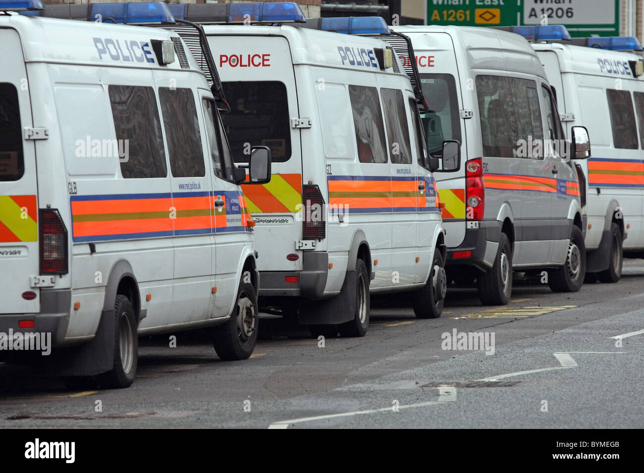 Police vans parked in a row by the side of a road Stock Photo - Alamy
