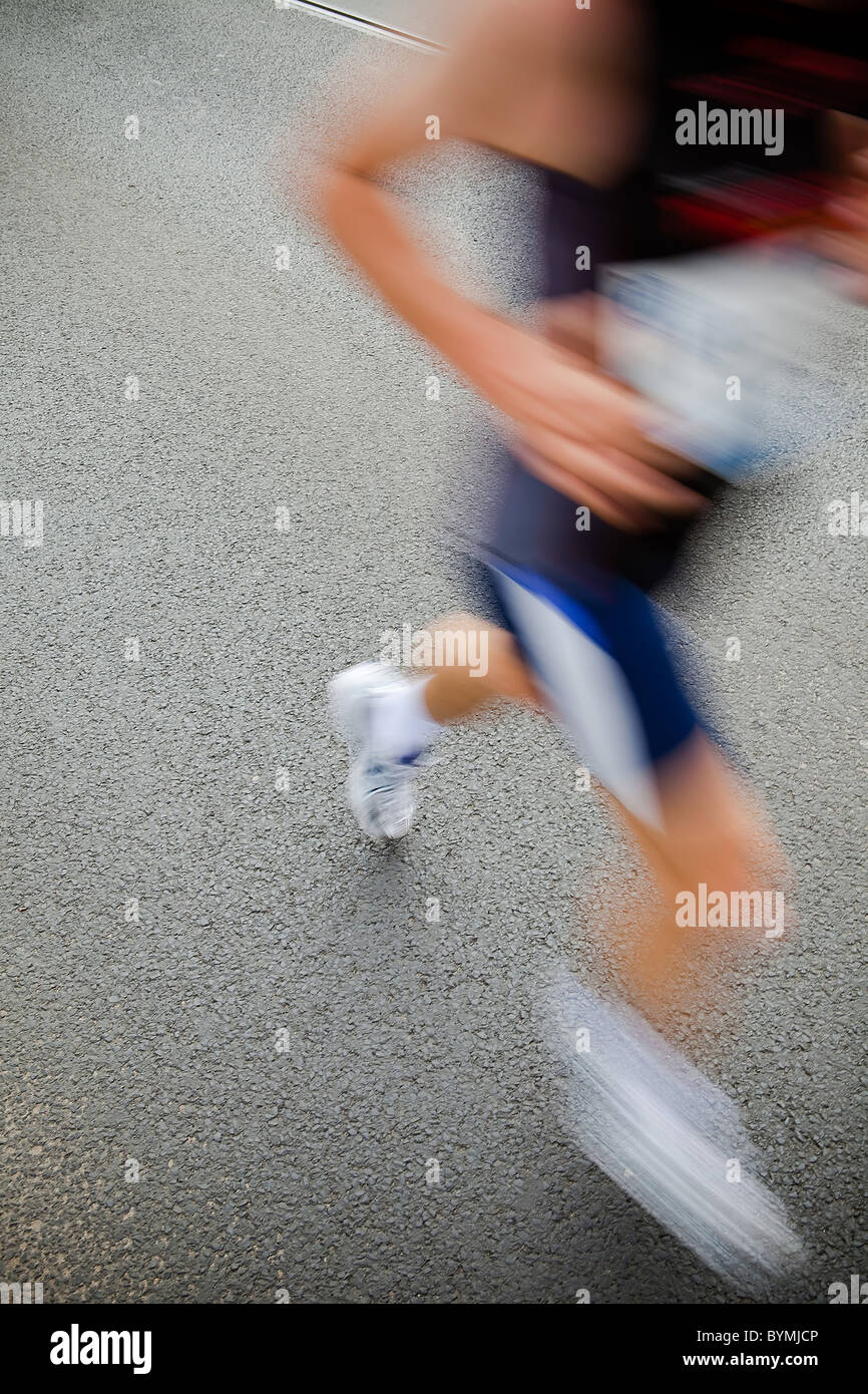 Man running in city marathon - motion blur Stock Photo - Alamy