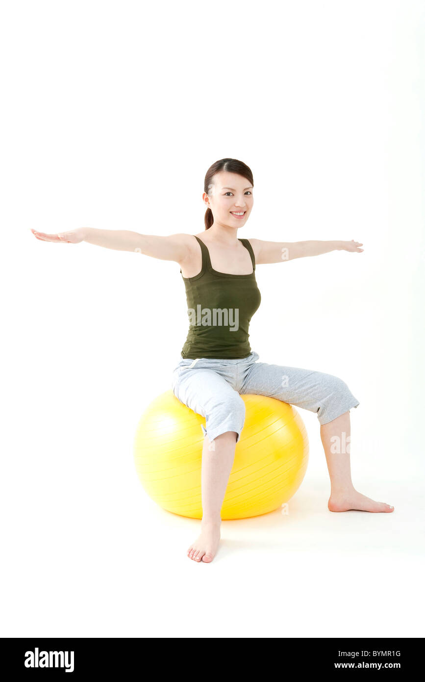 Young Woman Balancing on Fitness Ball Stock Photo - Alamy
