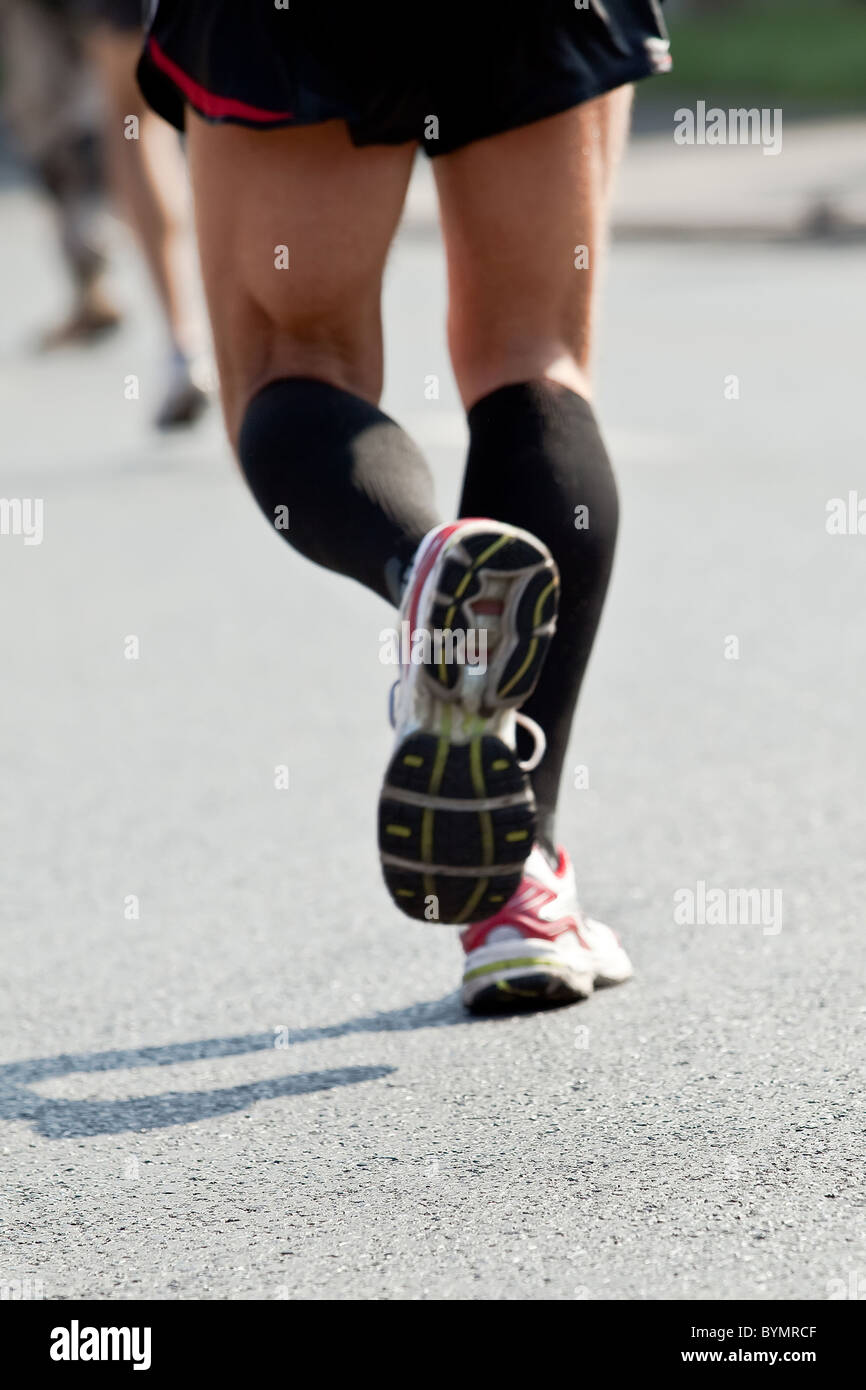 Man running in city marathon - motion blur Stock Photo - Alamy