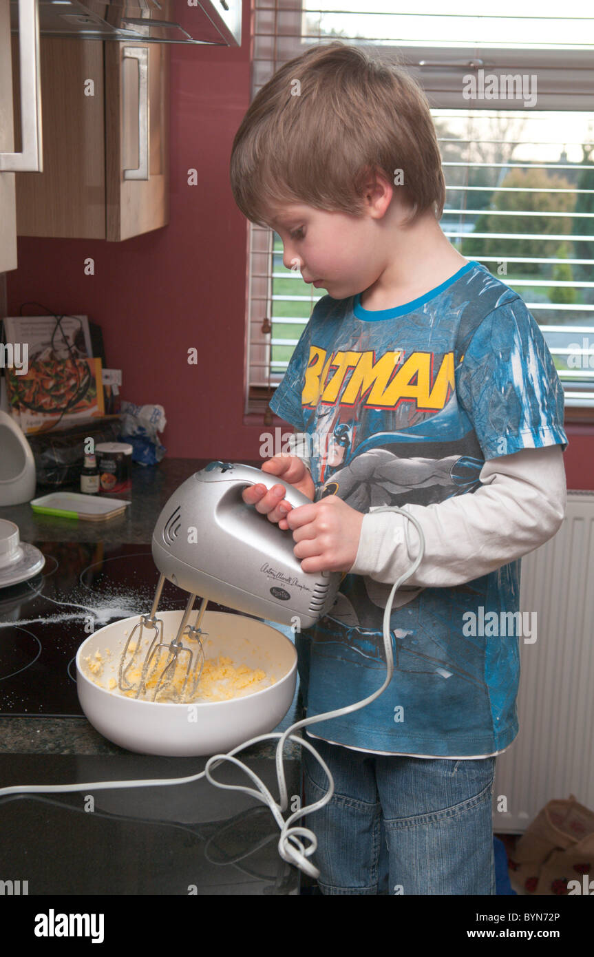 child boy using food mixer making a cake. Four year old Stock Photo - Alamy