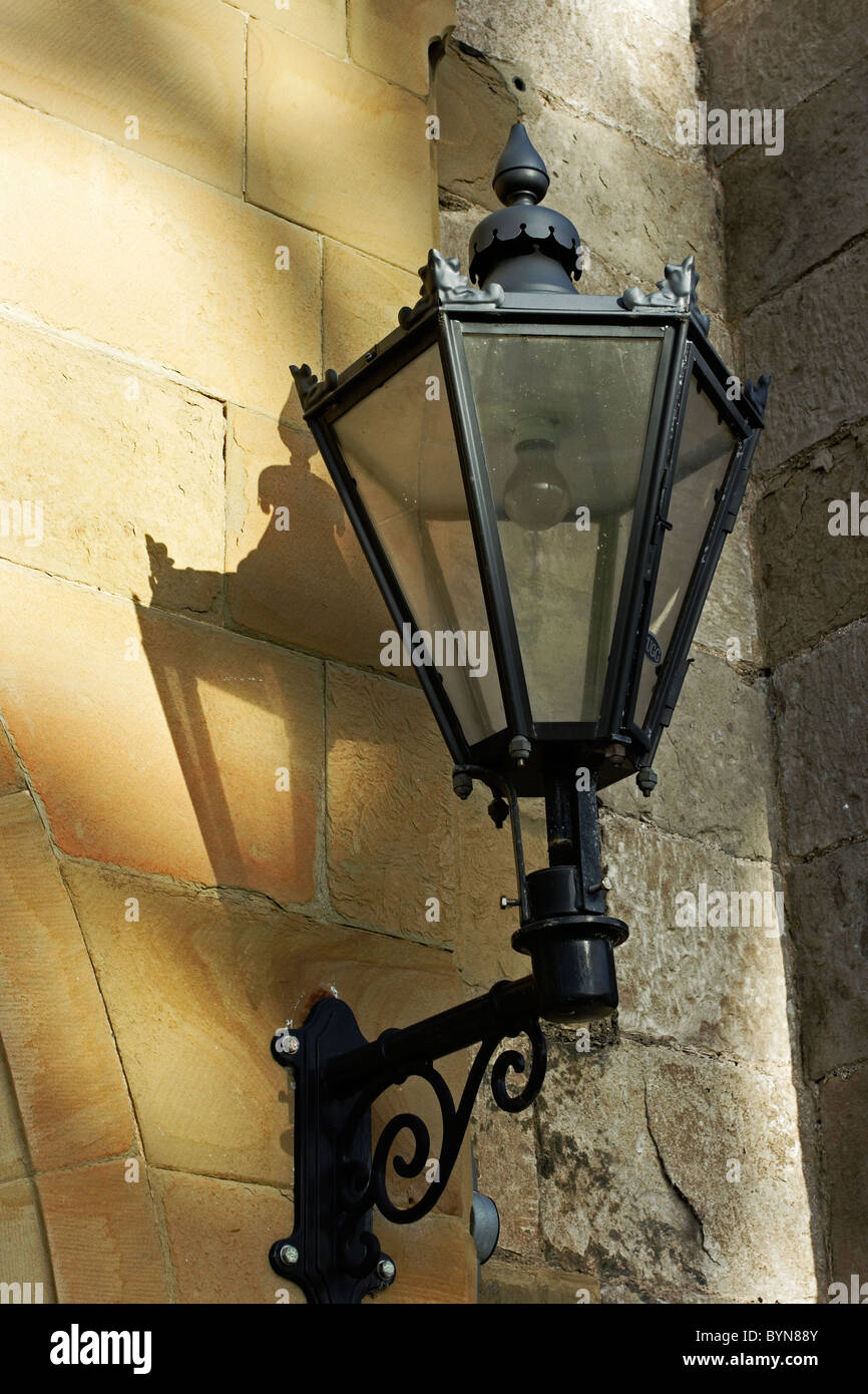 A Victorian/Edwardian style lamp mounted on a wall at St Asaph ...
