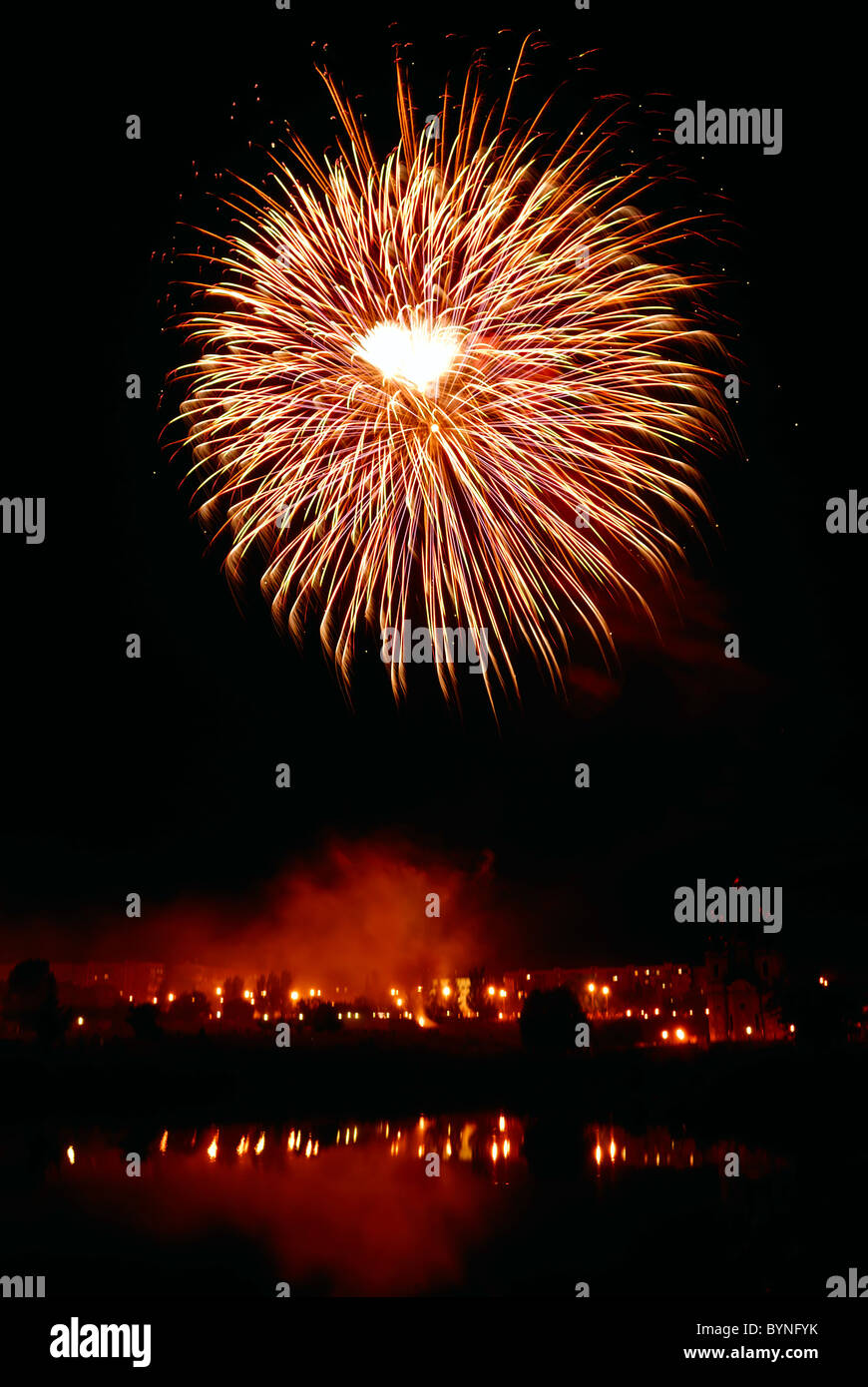 night traditional firework with reflection in water Stock Photo - Alamy