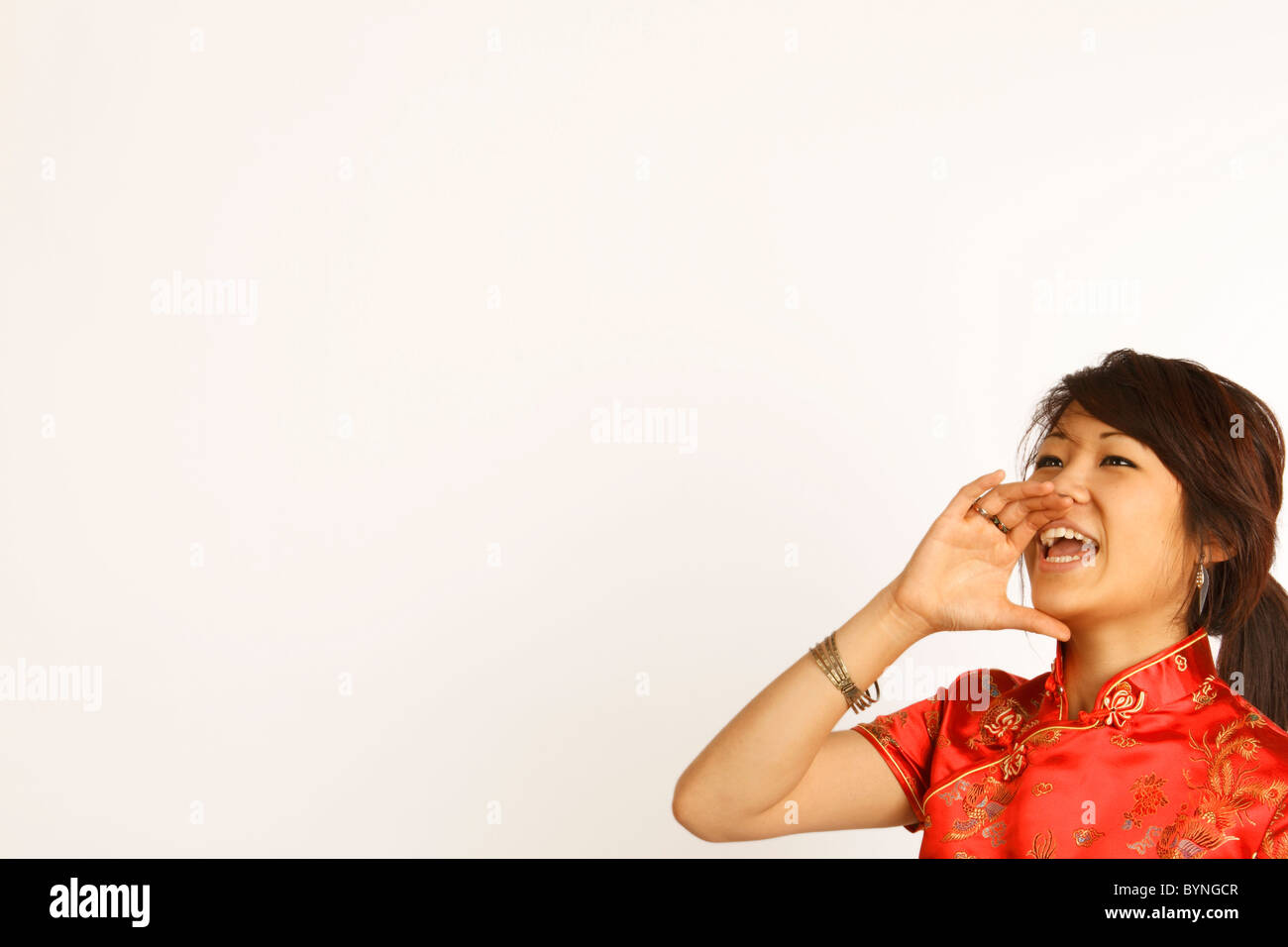young Chinese woman shouting through a cupped hand Stock Photo - Alamy