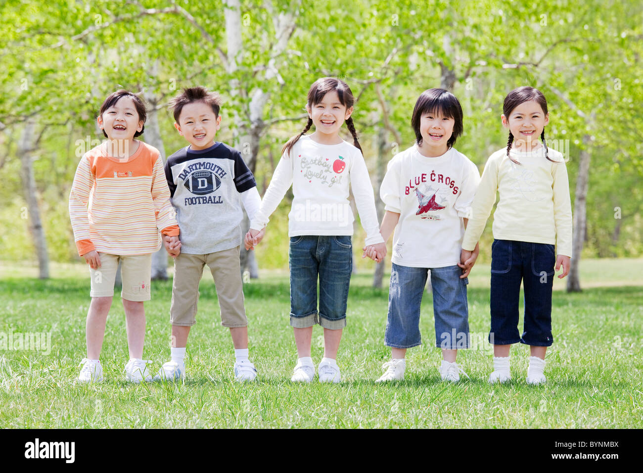 Kids Standing Holding Hands Looking At Camera Stock Photo - Alamy