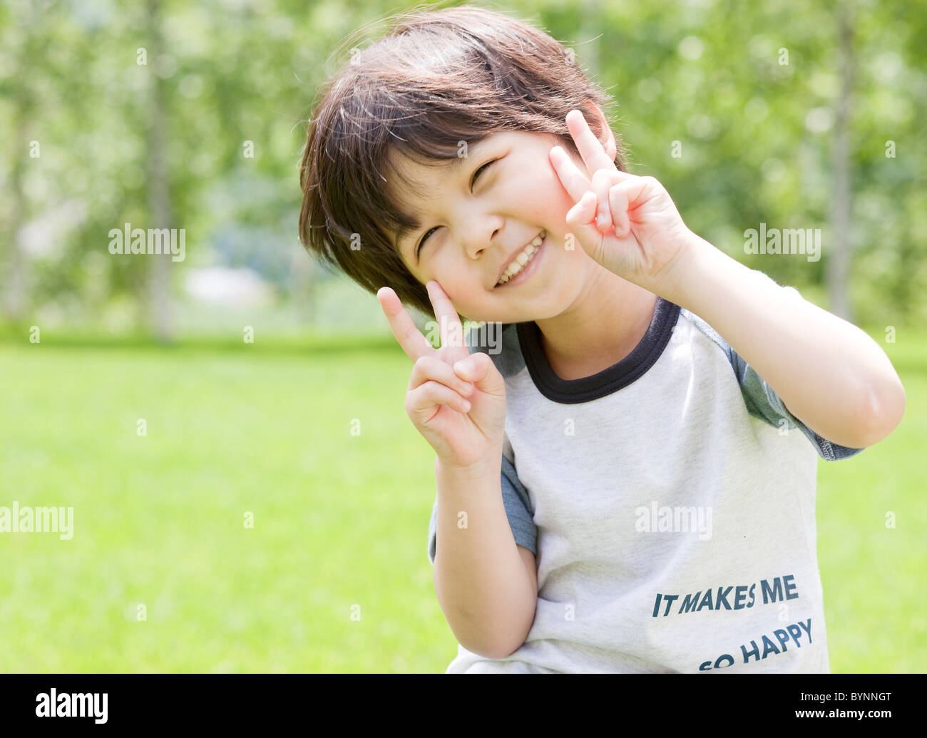 Boy Peace Sign Gesturing Smiling Stock Photo - Alamy