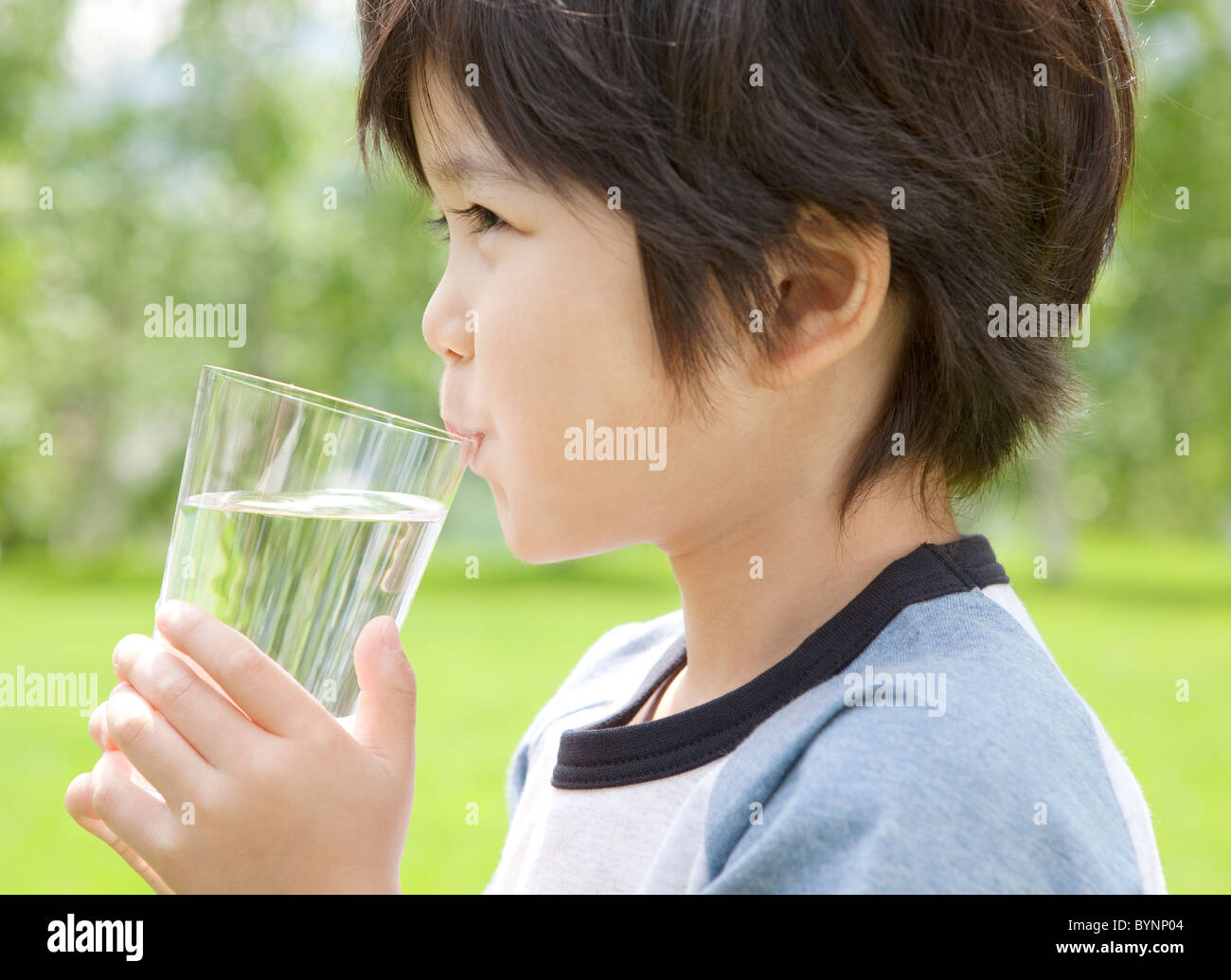 Boy Standing Holding Glass Drinking Water Stock Photo - Alamy